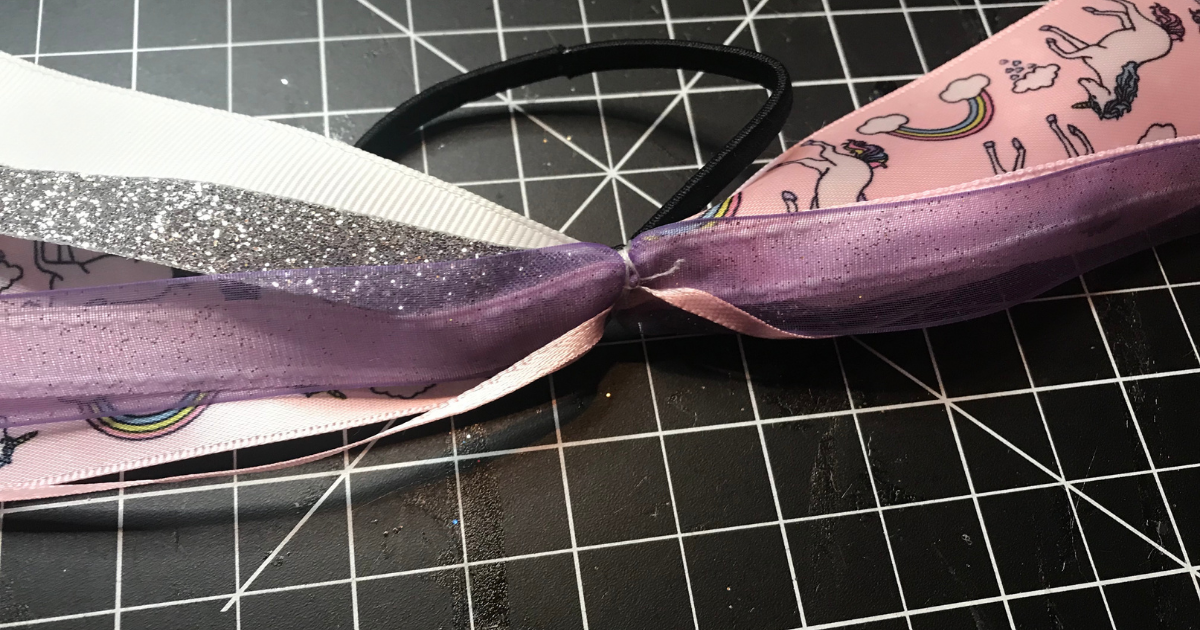 #5 Now sew the ribbons to the elastic hair band. I did about 5 times ...